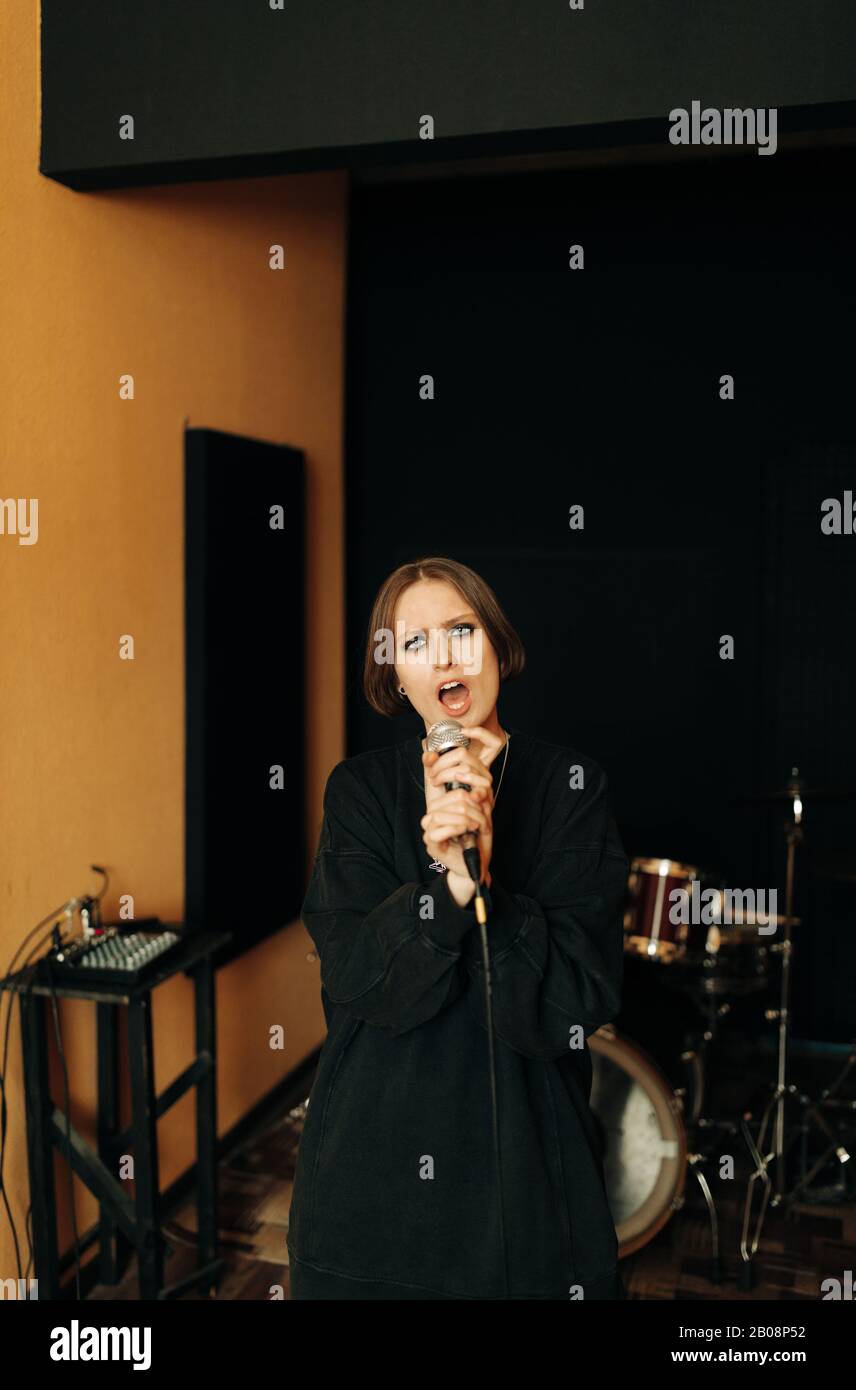 young musician with mic in recording studio Stock Photo - Alamy
