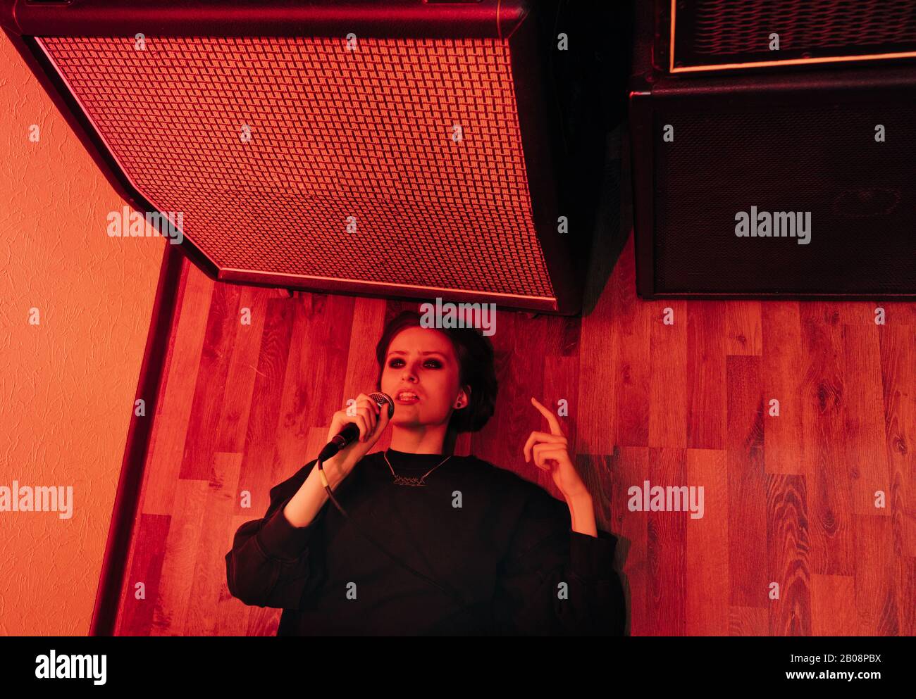 Singer performing in a recording studio, red flash Stock Photo - Alamy