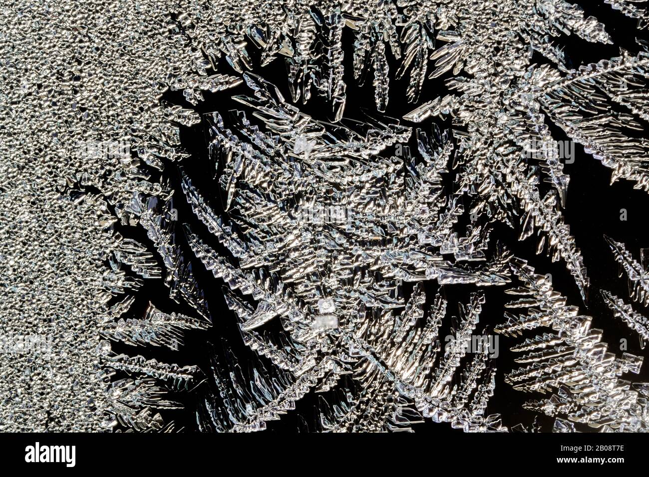 pattern of bright tiny ice crystals on black background Stock Photo - Alamy