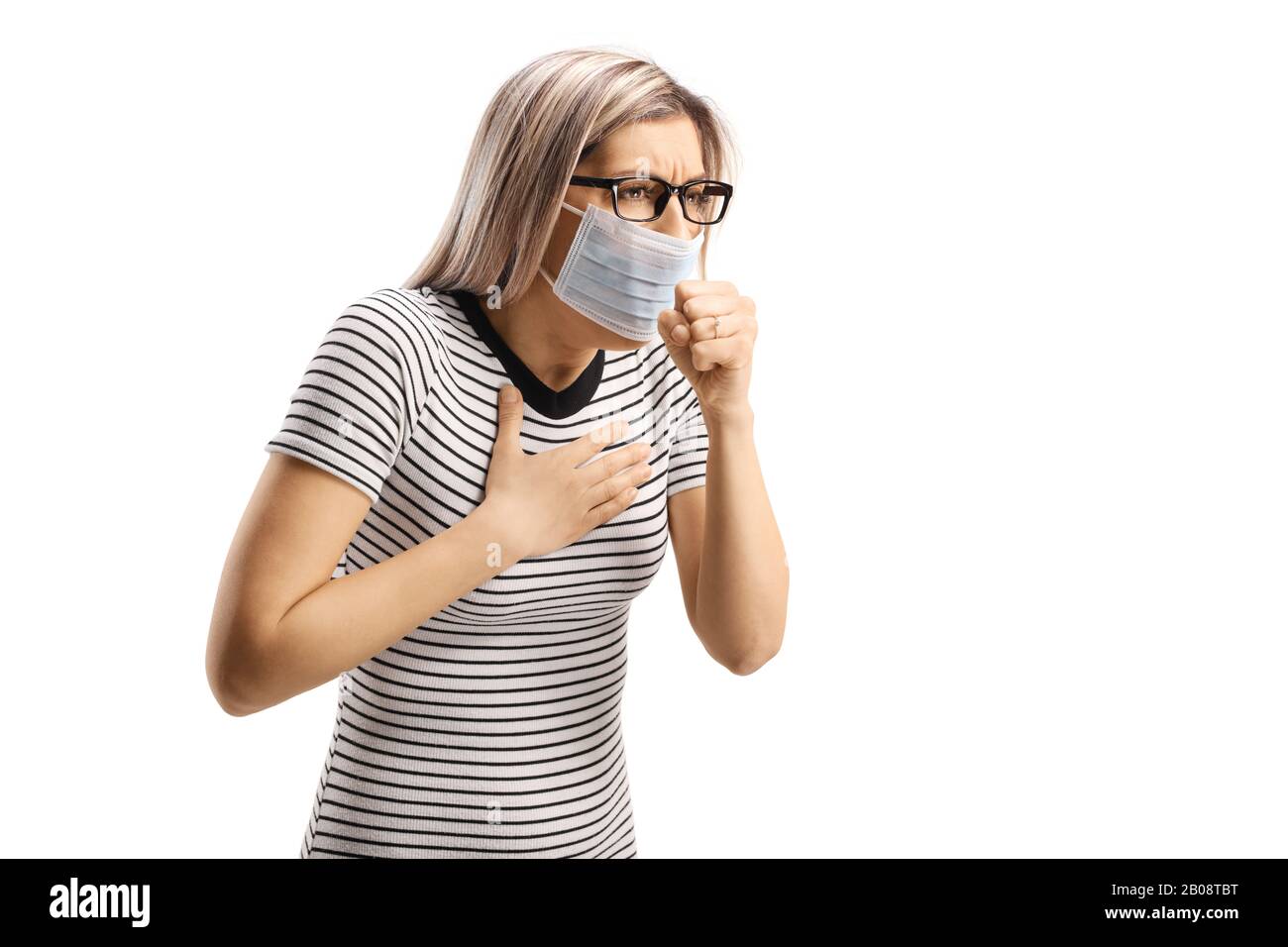 Young female wearing a mask and coughing isolated on white background ...