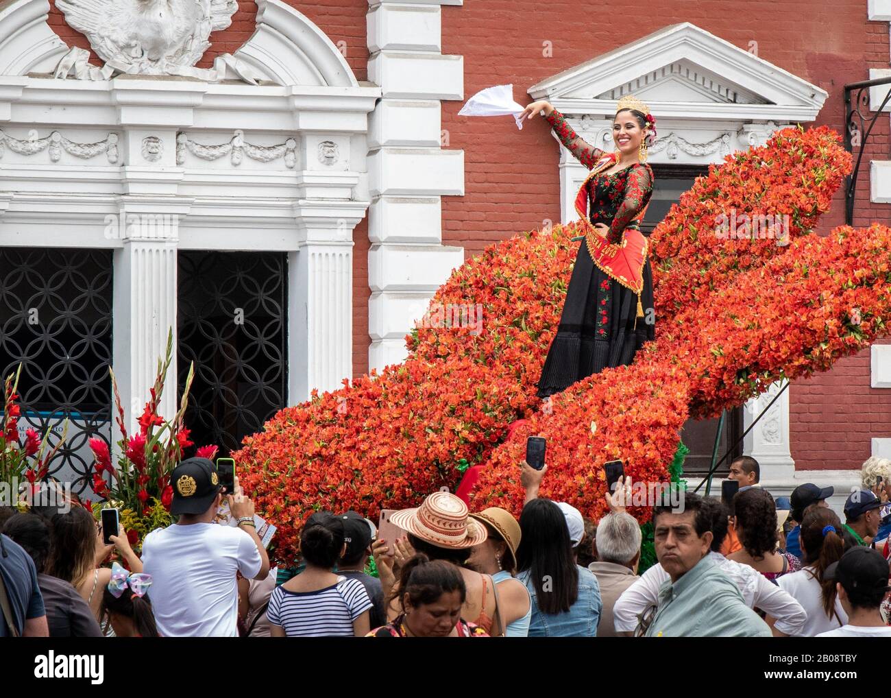 Woman dancer parades in traditional dress on flowery festival float at ...
