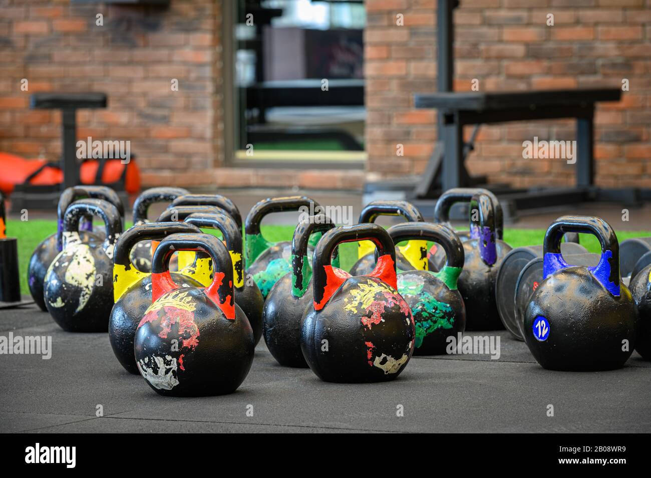 colored kettle bells in gym Stock Photo - Alamy