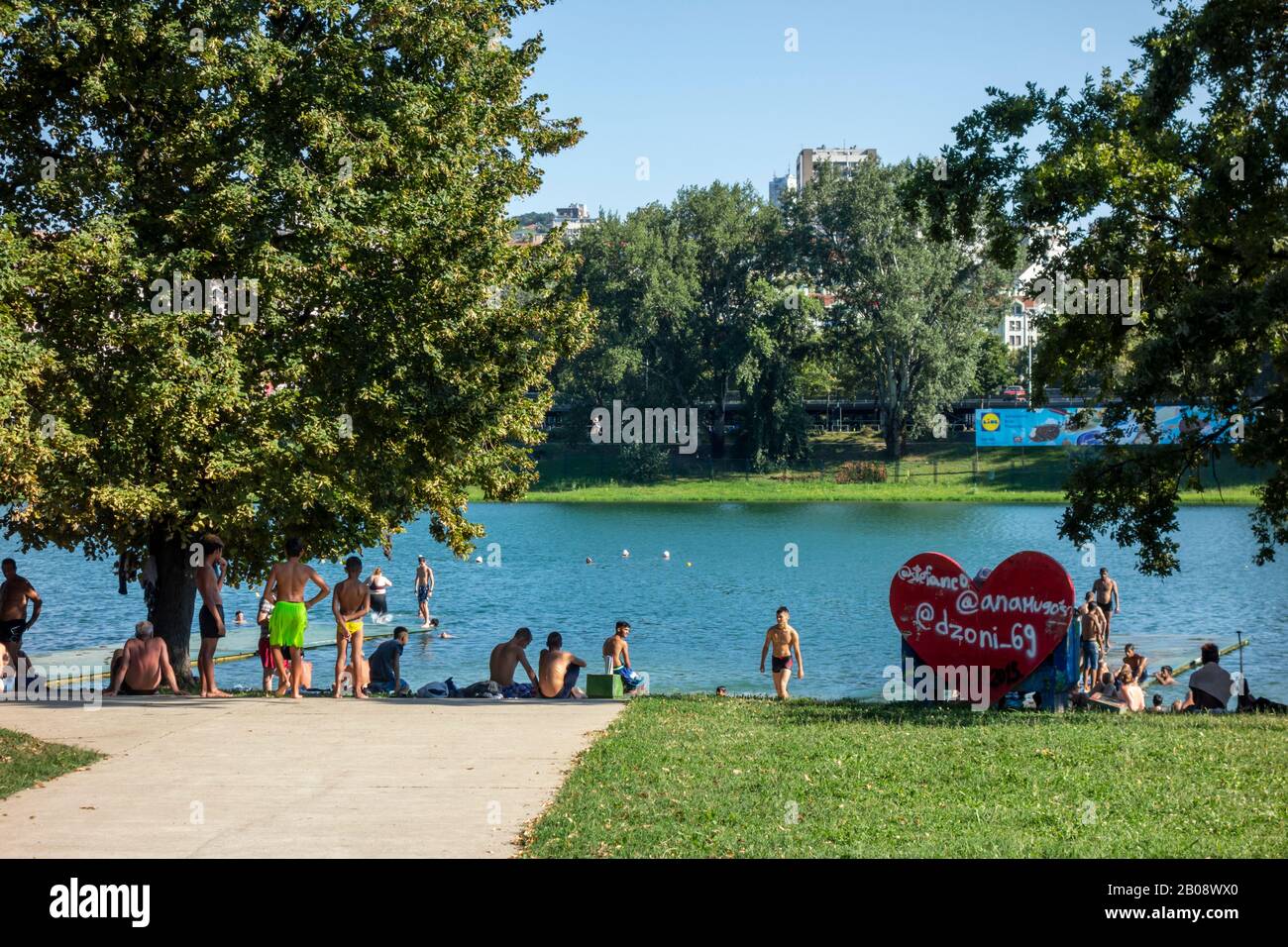People swimming and sunbathing at Ada Cingalija, the beach of Belgrade ...