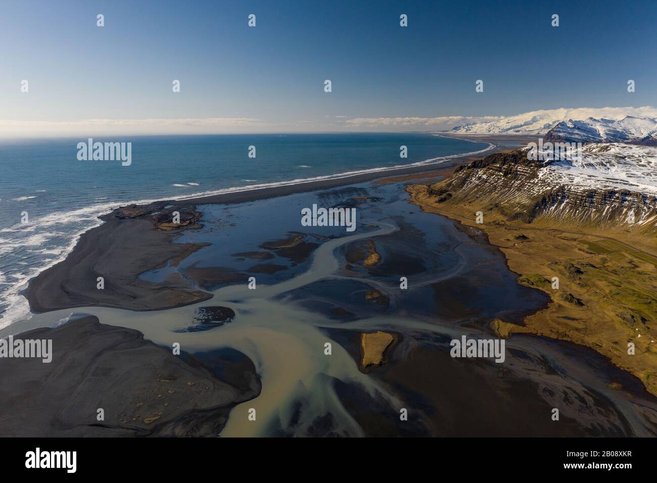 Aerial view of patterns of Icelandic rivers flowing into the ocean ...