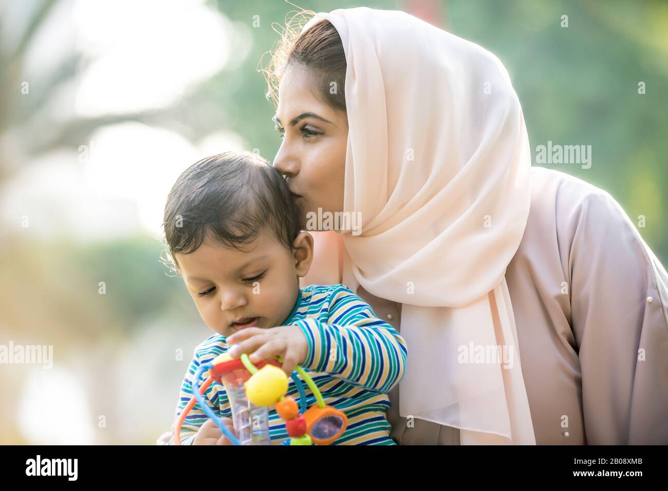 Mother and baby son lifestyle moments in Dubai. Young woman with her ...