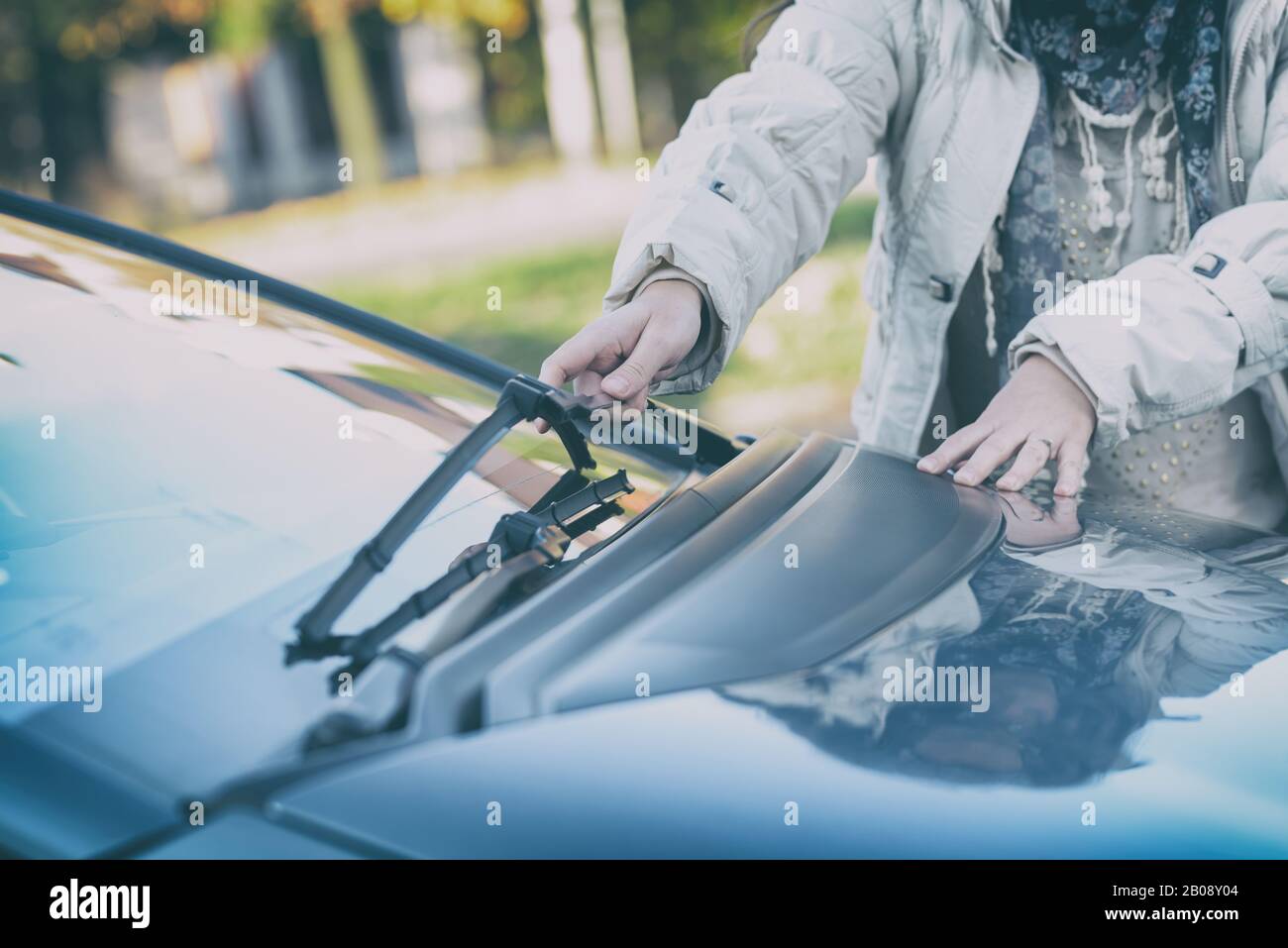 Woman's hand picking up windscreen wiper Stock Photo - Alamy