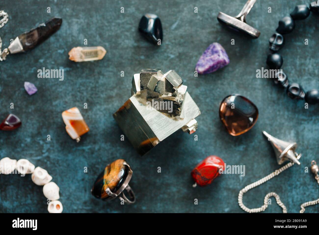Magic flat lay. Various precious and semiprecious stones on a blue ...