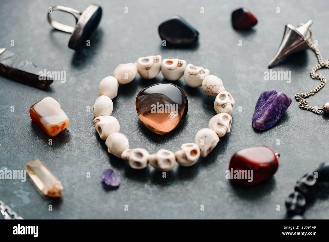 Magic flat lay. Various precious and semiprecious stones on a blue ...