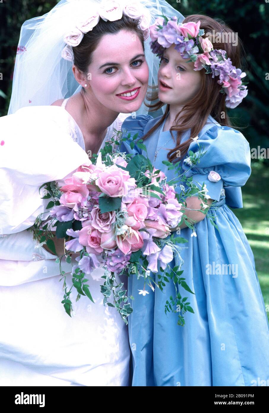 Bride and bridesmaid sharing a hug Stock Photo - Alamy