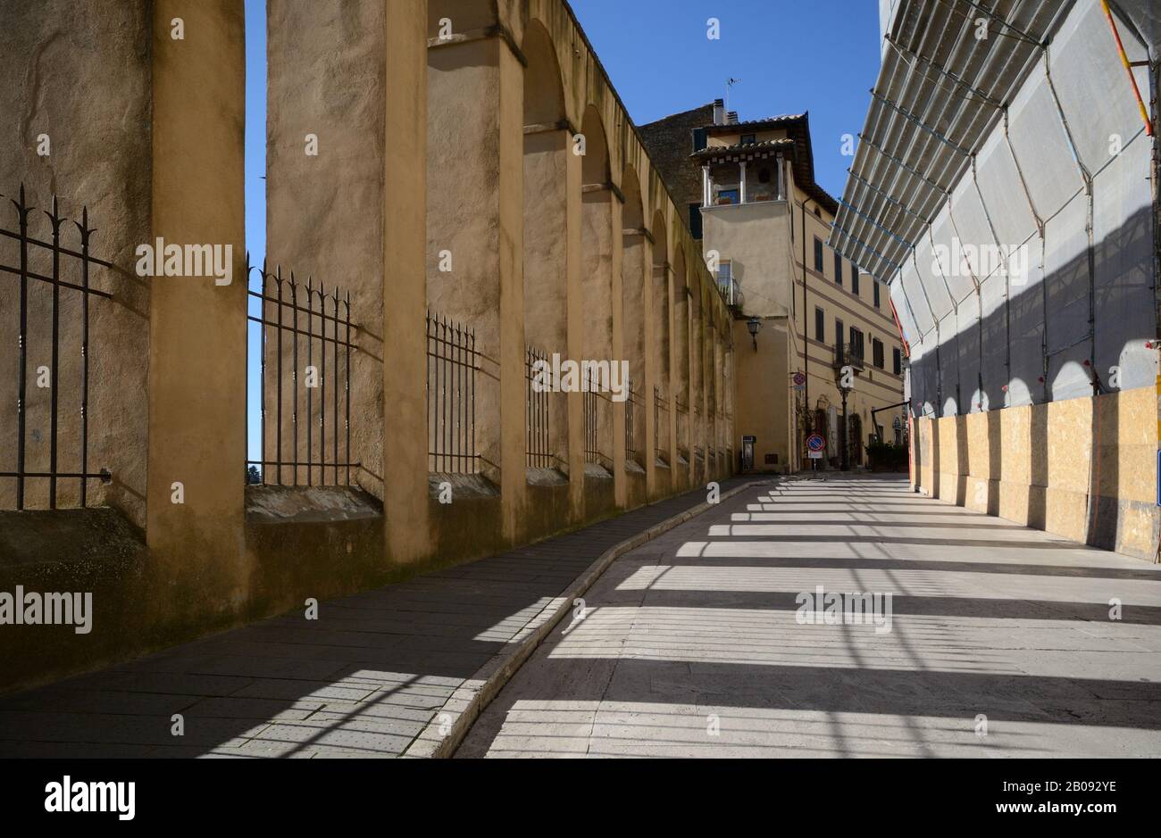 scenic view of the main street of Pitigliano town with the portico of ...