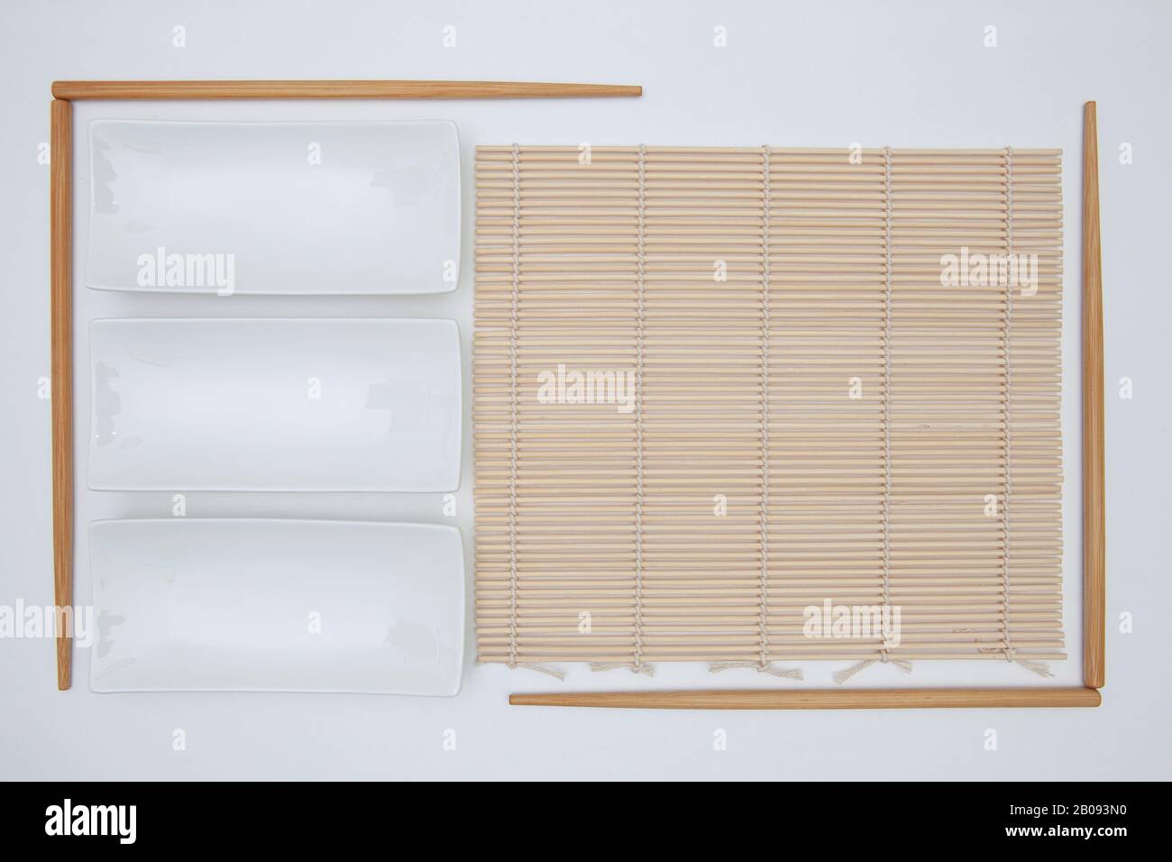 Top View Of White Empty Sushi Plates With Bamboo Chopsticks and Mat ...
