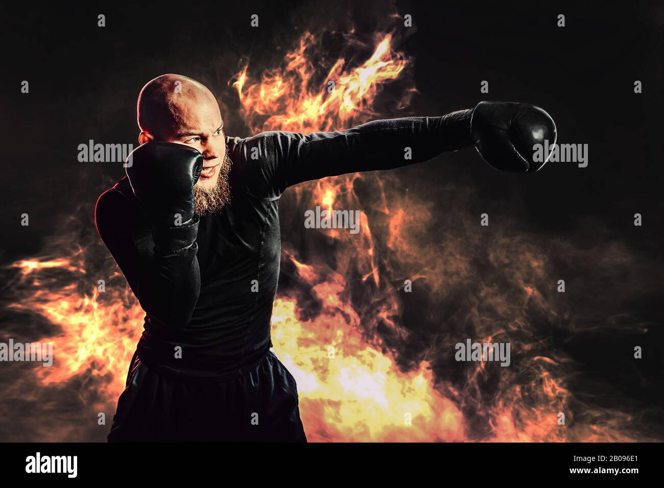 Sportsman boxer training, hitting direct hit on background with fire ...