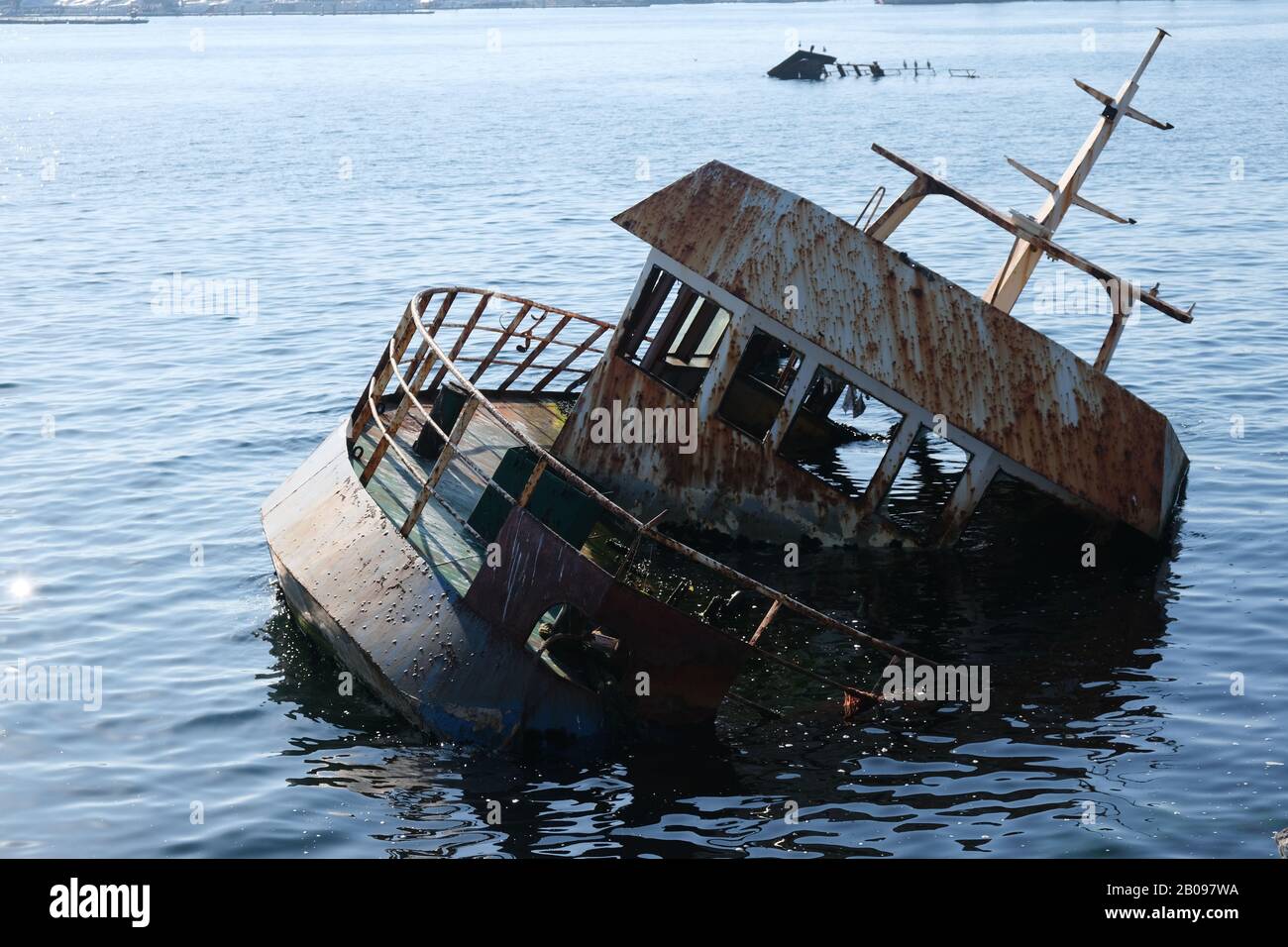 sunken boat near the rocks Stock Photo - Alamy