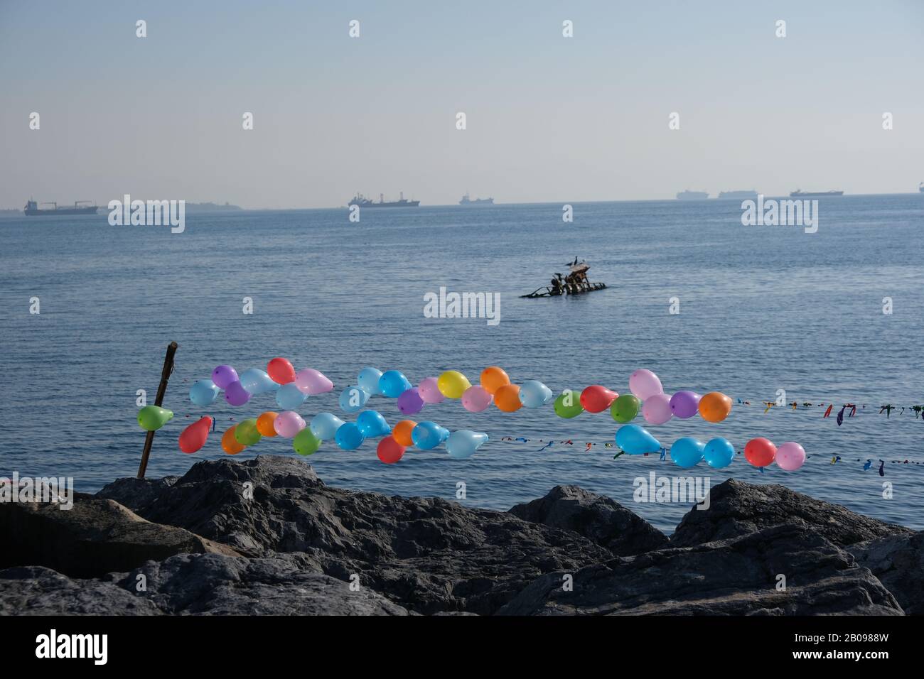Colorful balloons on the rock beach Stock Photo - Alamy