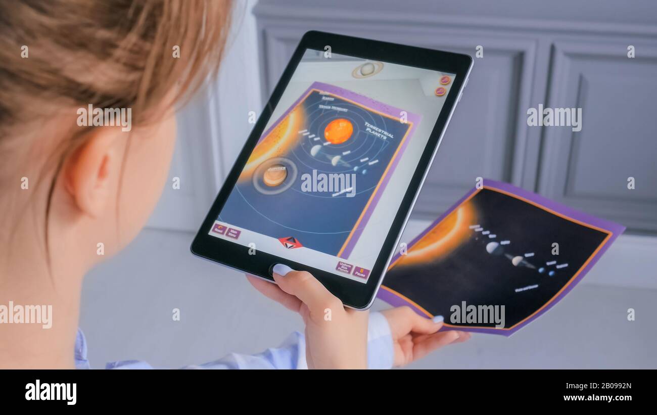 Woman using tablet with augmented reality app - 3d planets of solar ...