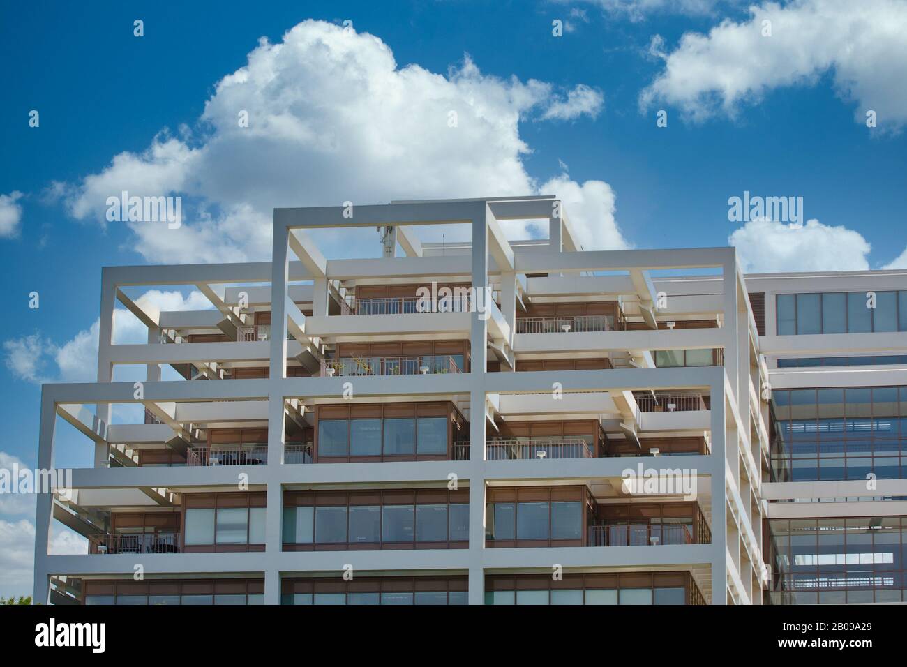 White Terraced Office Tower Under Nice Skies Stock Photo - Alamy
