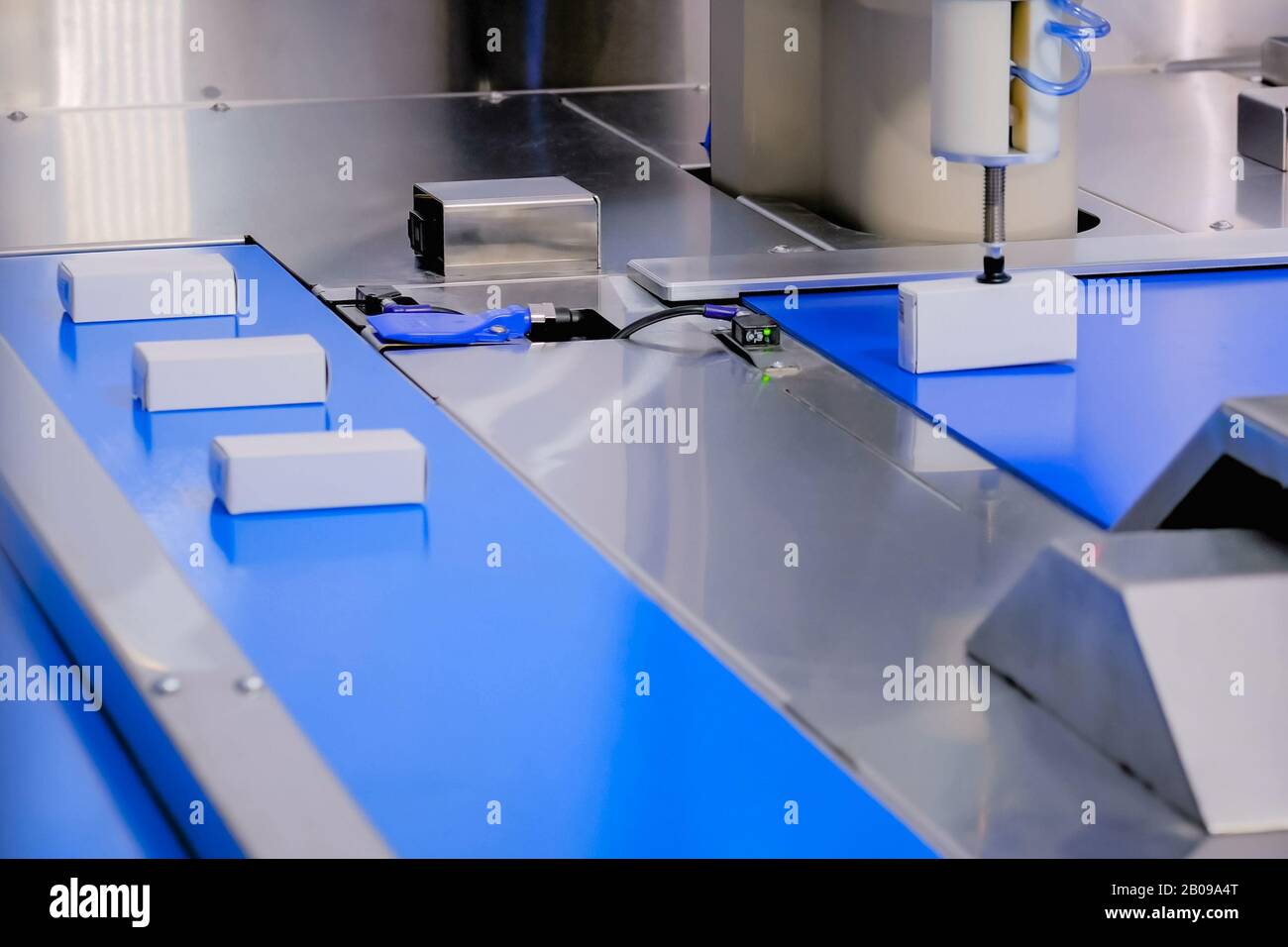 Automatic sorting conveyor system - moving white small cardboard boxes ...