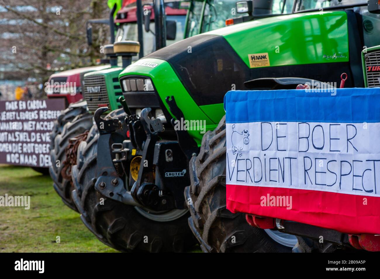 A group of tractors decorated with placards arrive during the protest ...