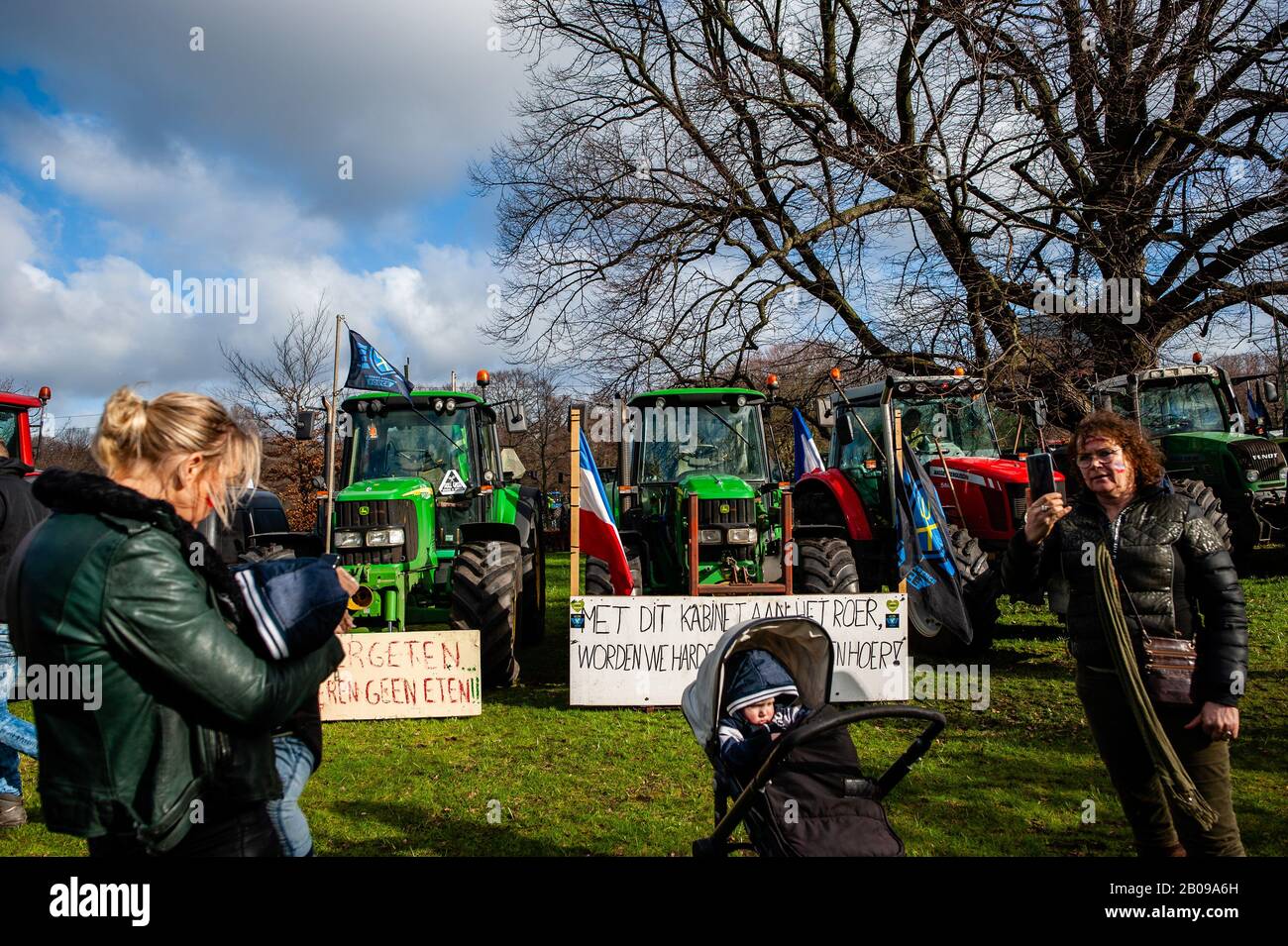 Women with their children take photos of tractors during the protest ...