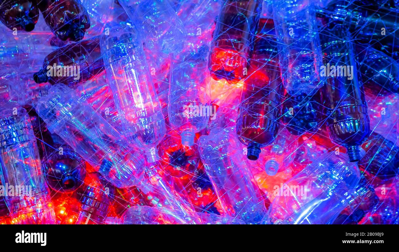 Ecology concept - plastic bottle installation with blue and red ...