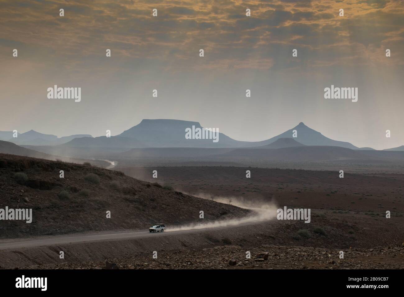 safari car traveling fast through a scenic landscape in africa, namibia ...