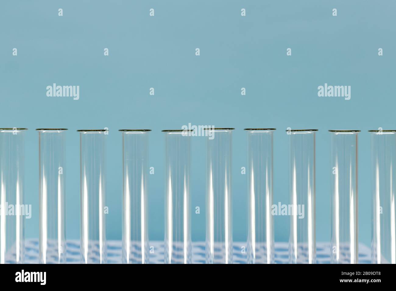 One row of horizontally constructed test tubes on a gray-blue ...