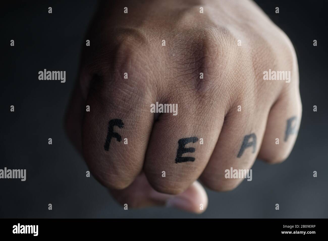fear word written on human hand, close up Stock Photo - Alamy