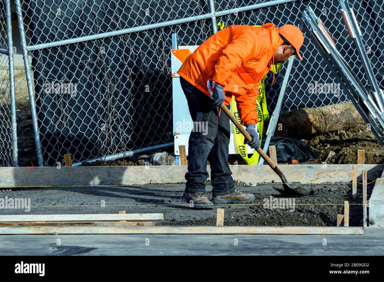 Concrete construction contractor installing a sidewalk, curb and storm ...