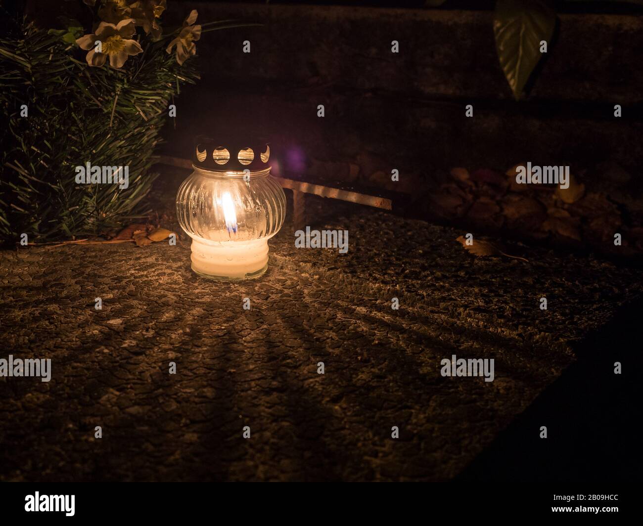 The cemetery torch burns with a bright light in the dark night and ...