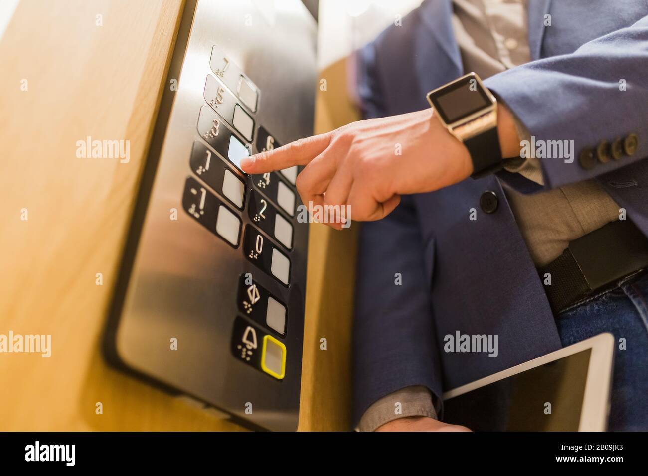 Close up of businessman pressing third floor control panel button in ...