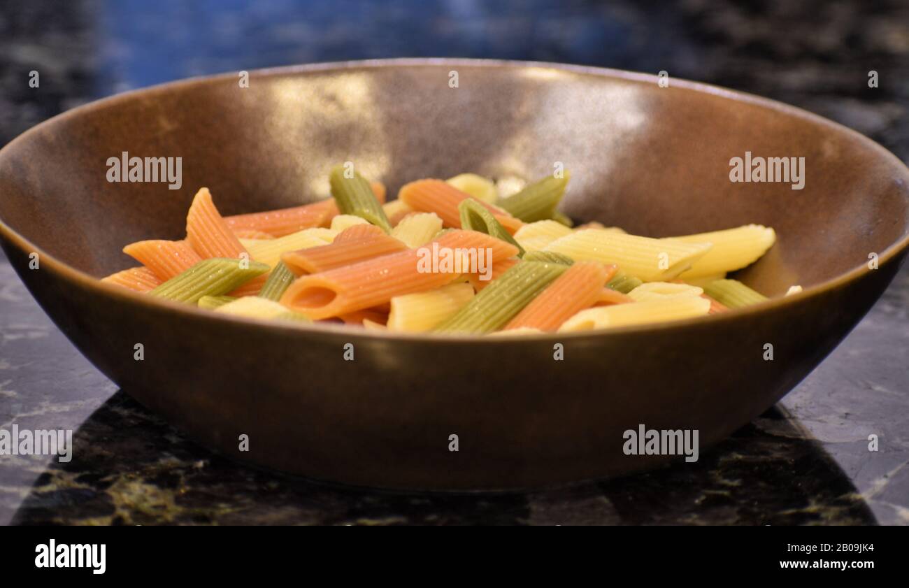 yummy tri-colored penne pasta dish Stock Photo - Alamy