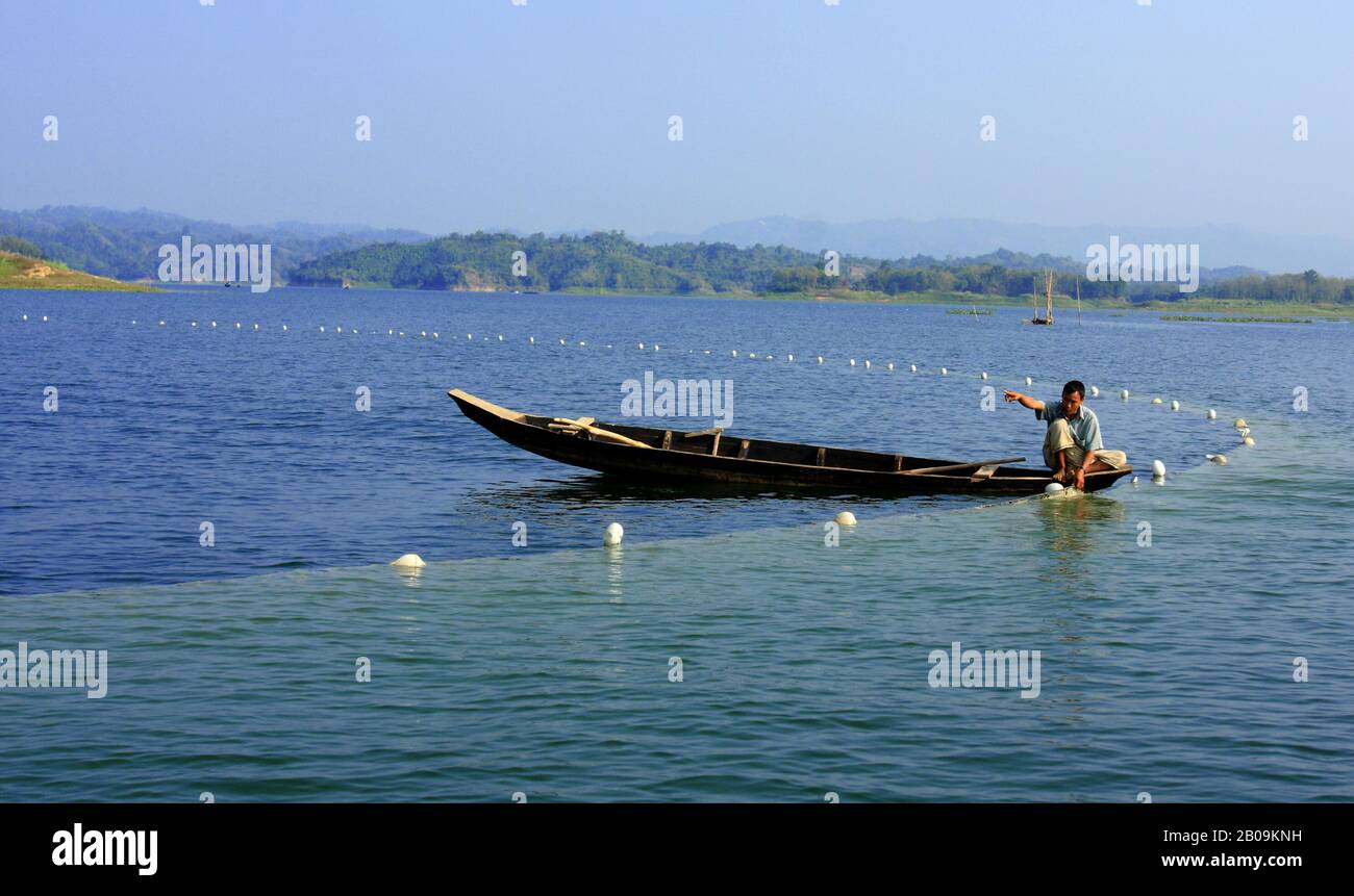 Fisherman catches fish in Kaptai Lake. Rangamati, Bangladesh. 2009 ...
