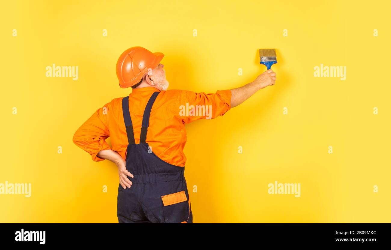 Welcome to my place painter in working uniform working indoor. man with ...