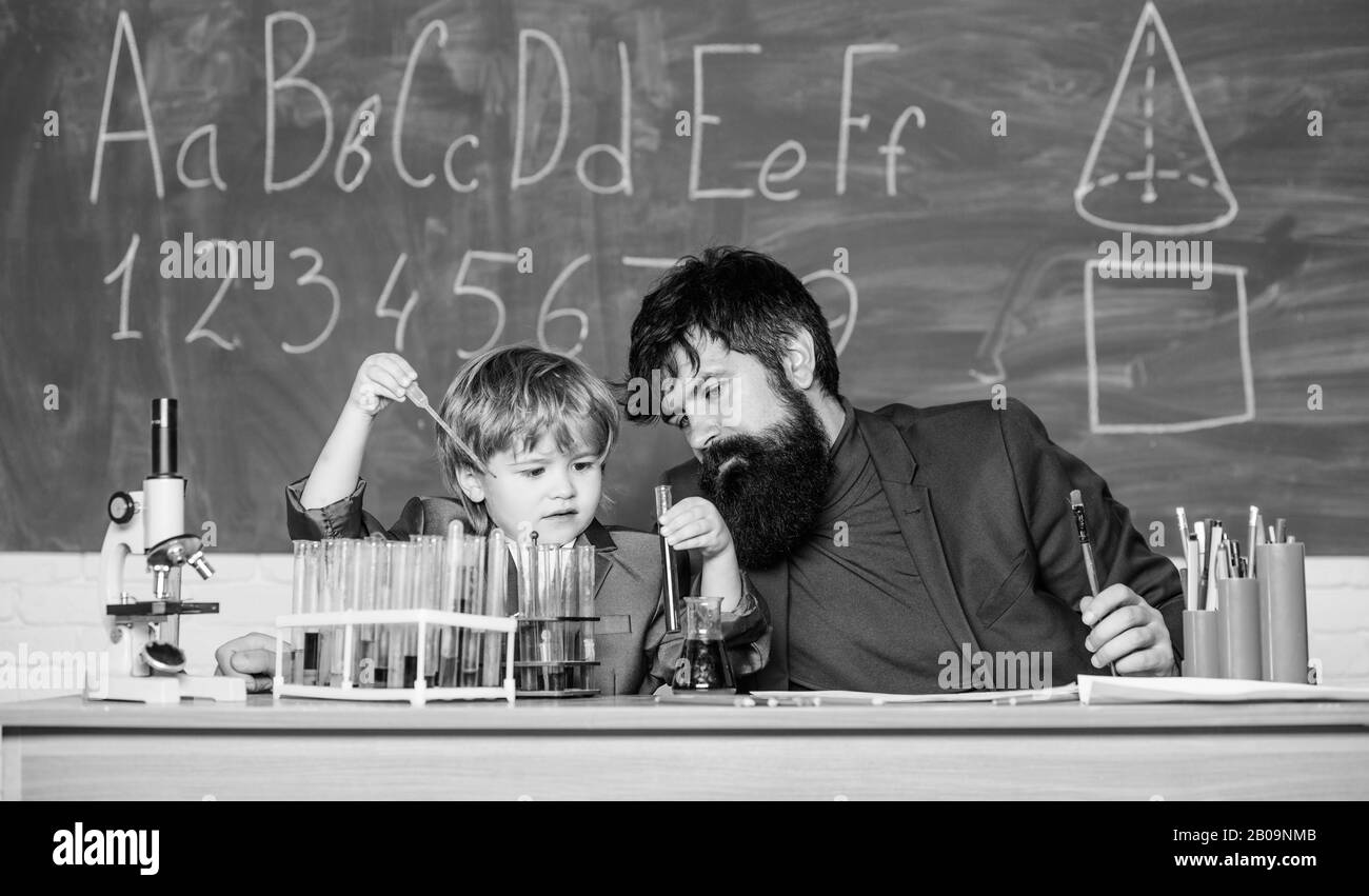 father and son at school. Back to school. using microscope in lab ...