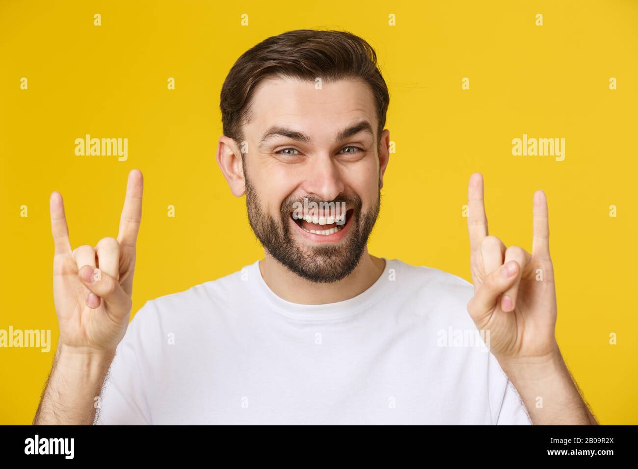 Young caucasian man wearing casual white t-shirt over yellow isolated ...
