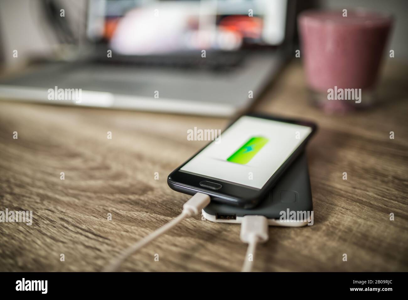 Charging mobile phone with power bank with charging mark on the screen ...