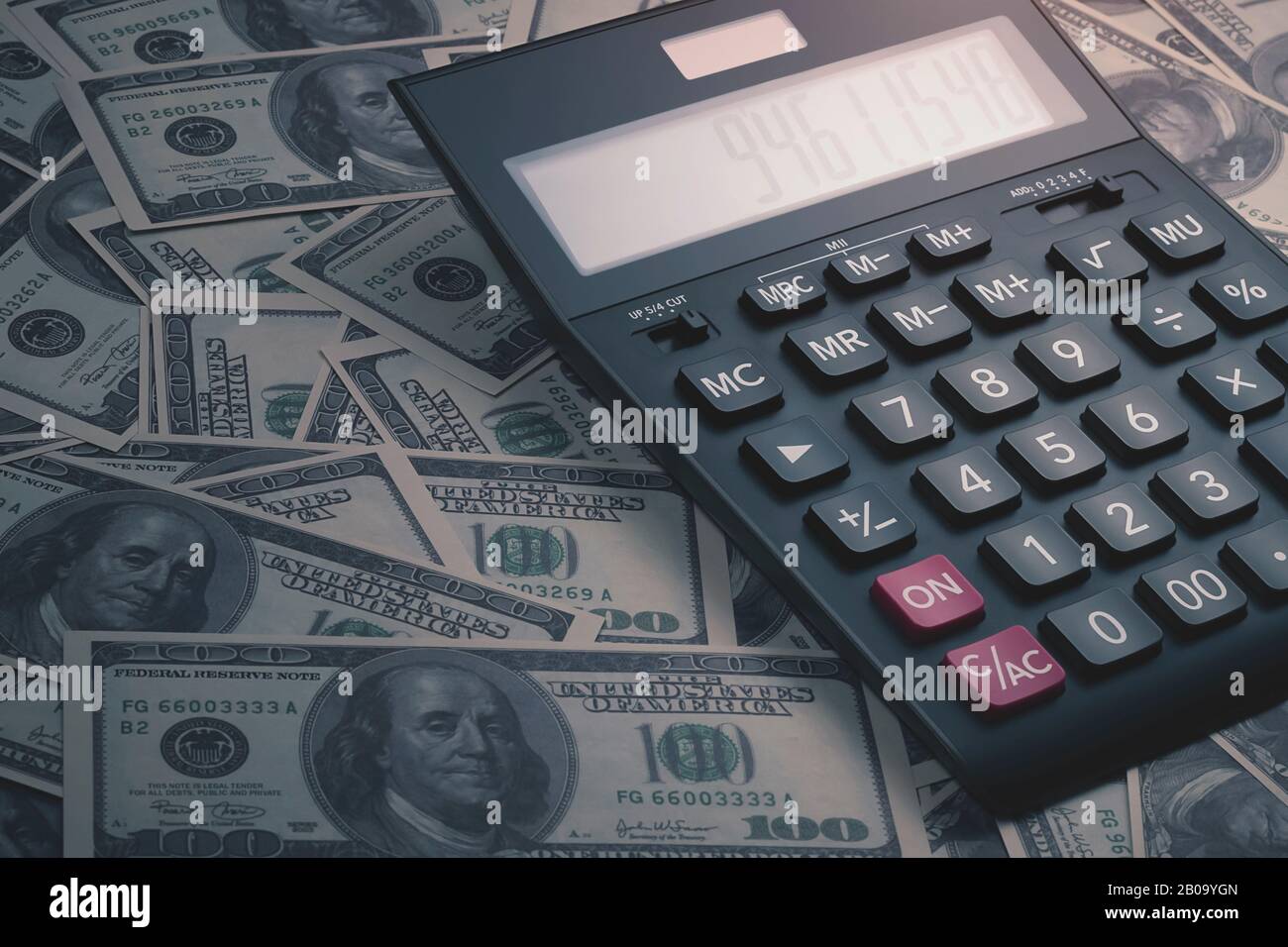 Side view of a black accounting calculator with numbers on display ...