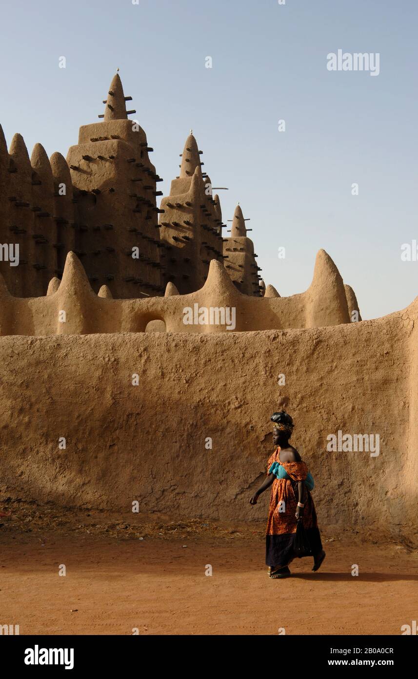 MALI, DJENNE, PEOPLE WALKING IN FRONT OF MOSQUE, MUD BRICK BUILDING ...