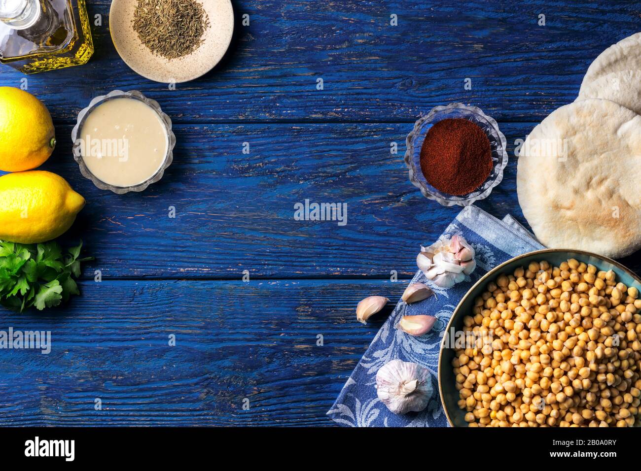 Chickpeas and various middle-eastern vegetarian ingredients on a dark ...