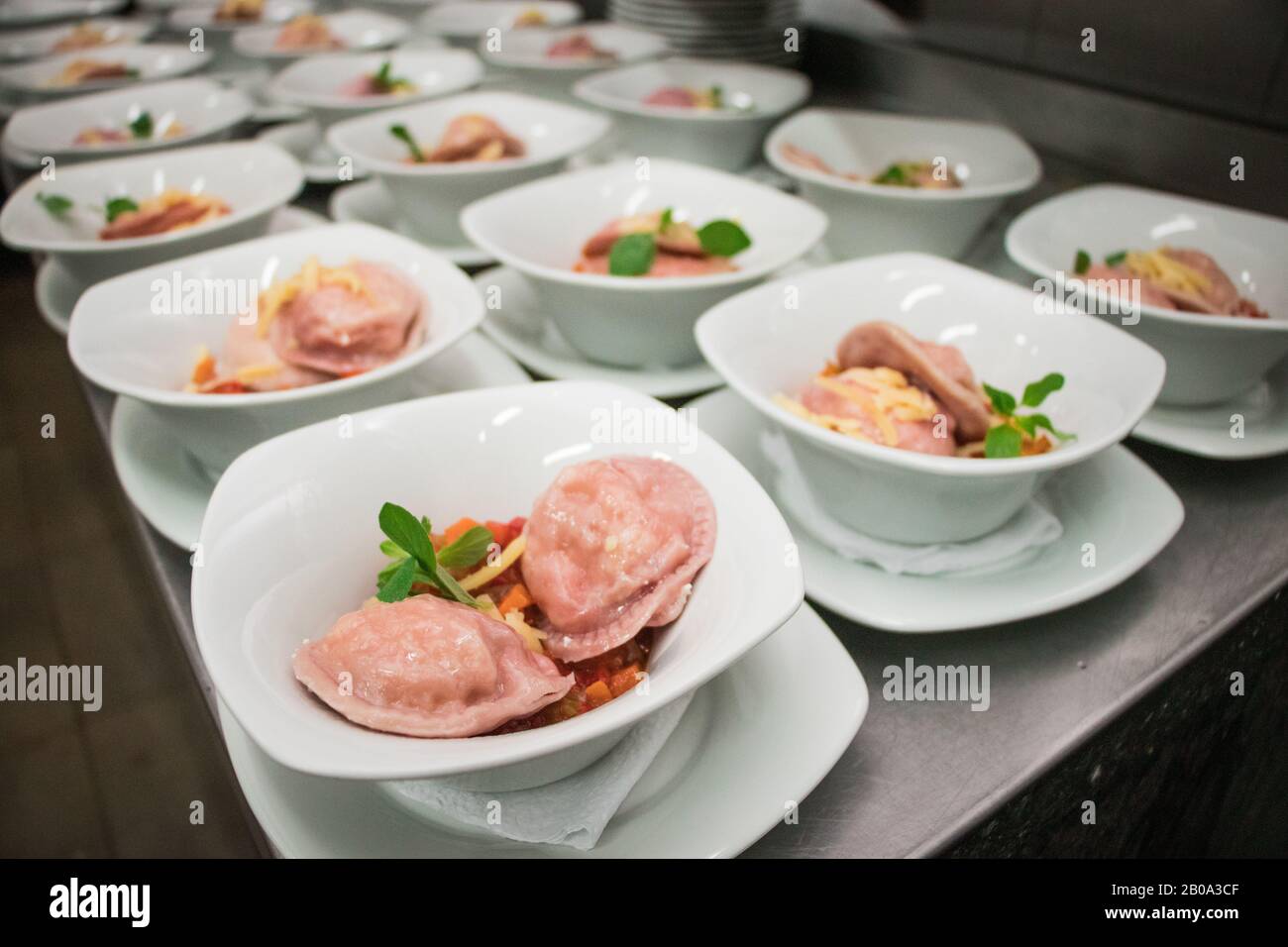 Pink ravioli with basil on plate Stock Photo - Alamy