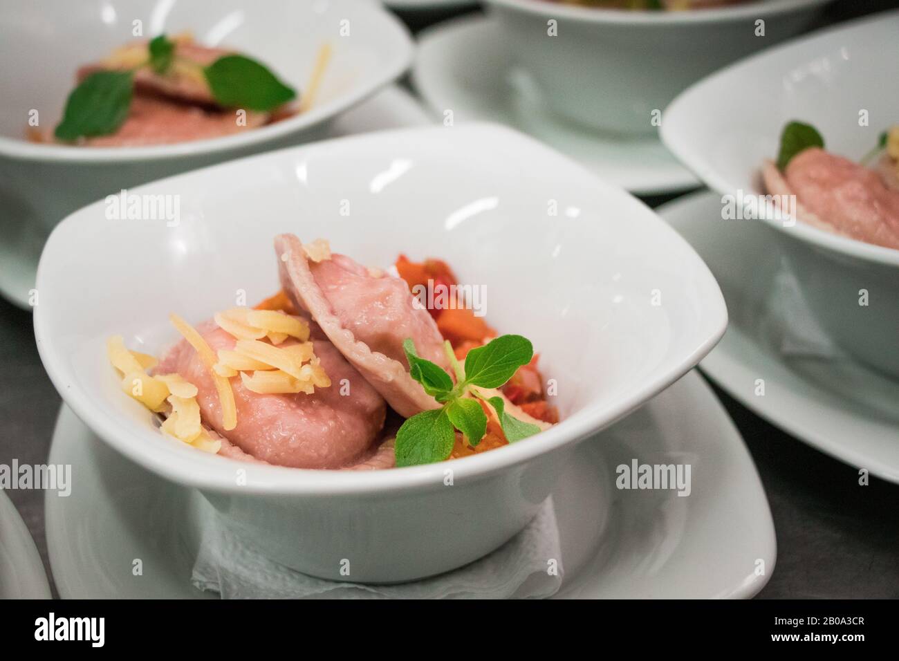 Pink ravioli with basil on plate Stock Photo - Alamy
