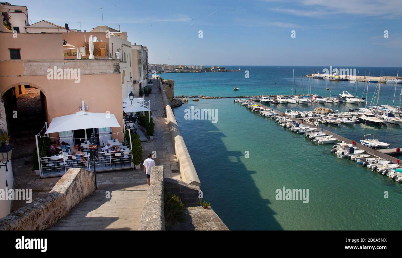 Looking down from the castle battlements to the marina at Otranto, a ...