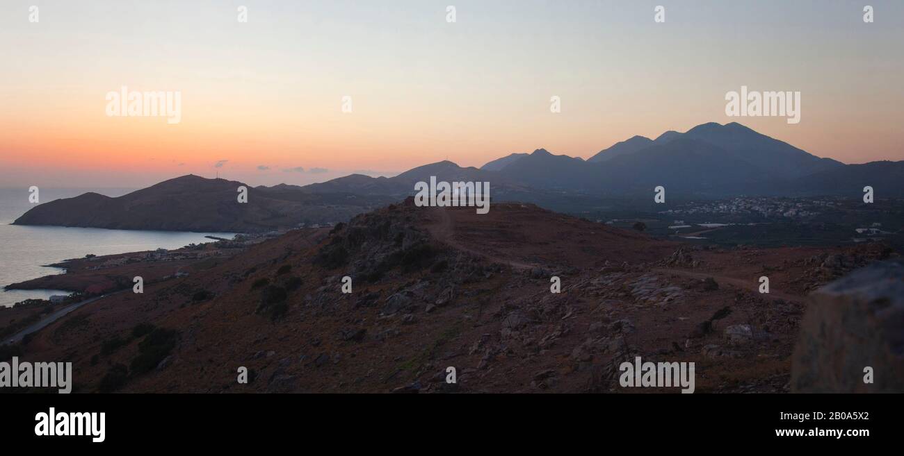 Sunrise over Panormos ( to left of image ) in Crete. Panormos is a ...