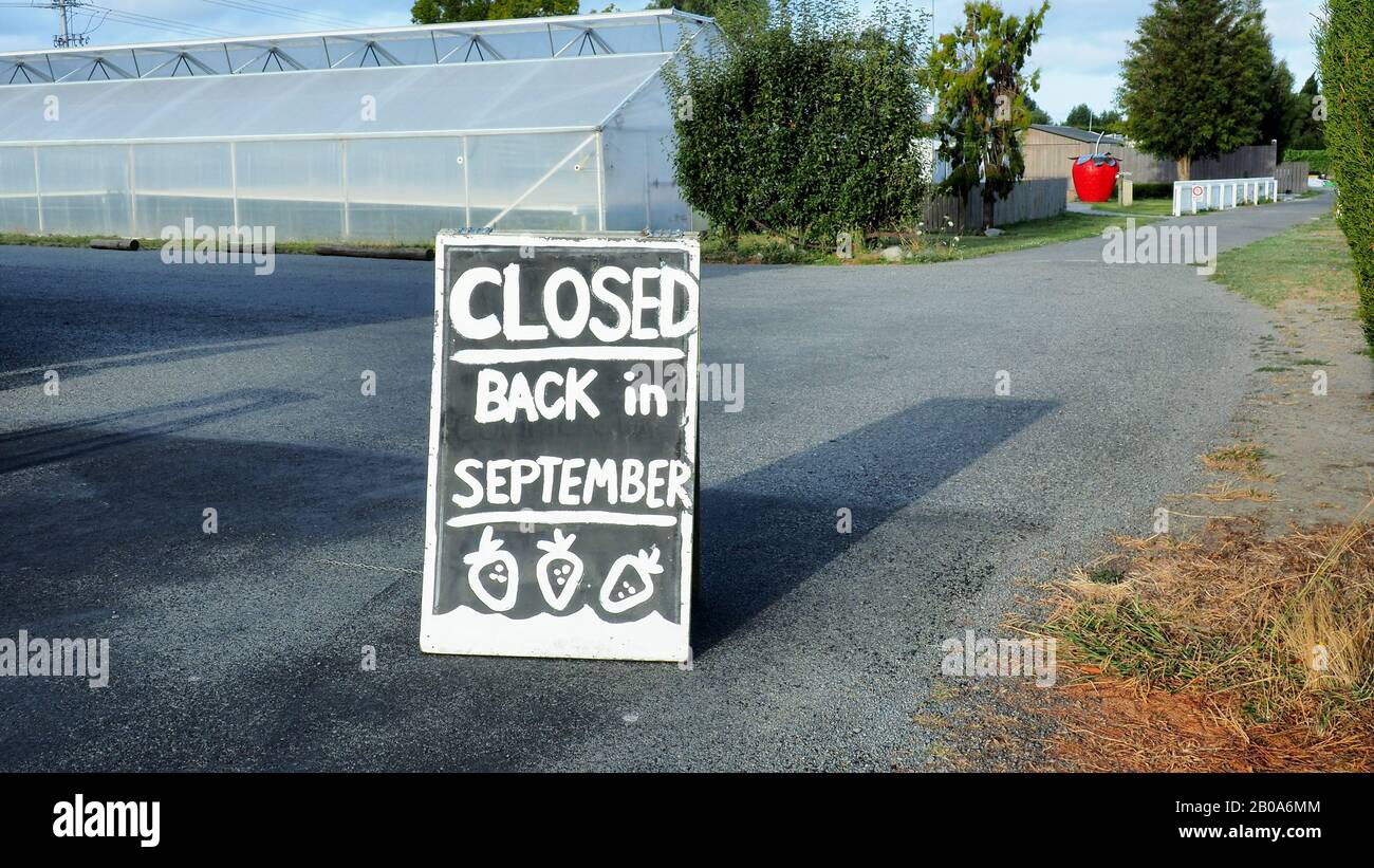 Friendly sign for a New Zealand strawberry farm closed in late summer ...