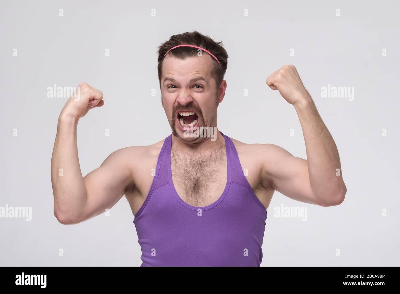 Successful young caucasian male sportsman screaming Yes and raising ...