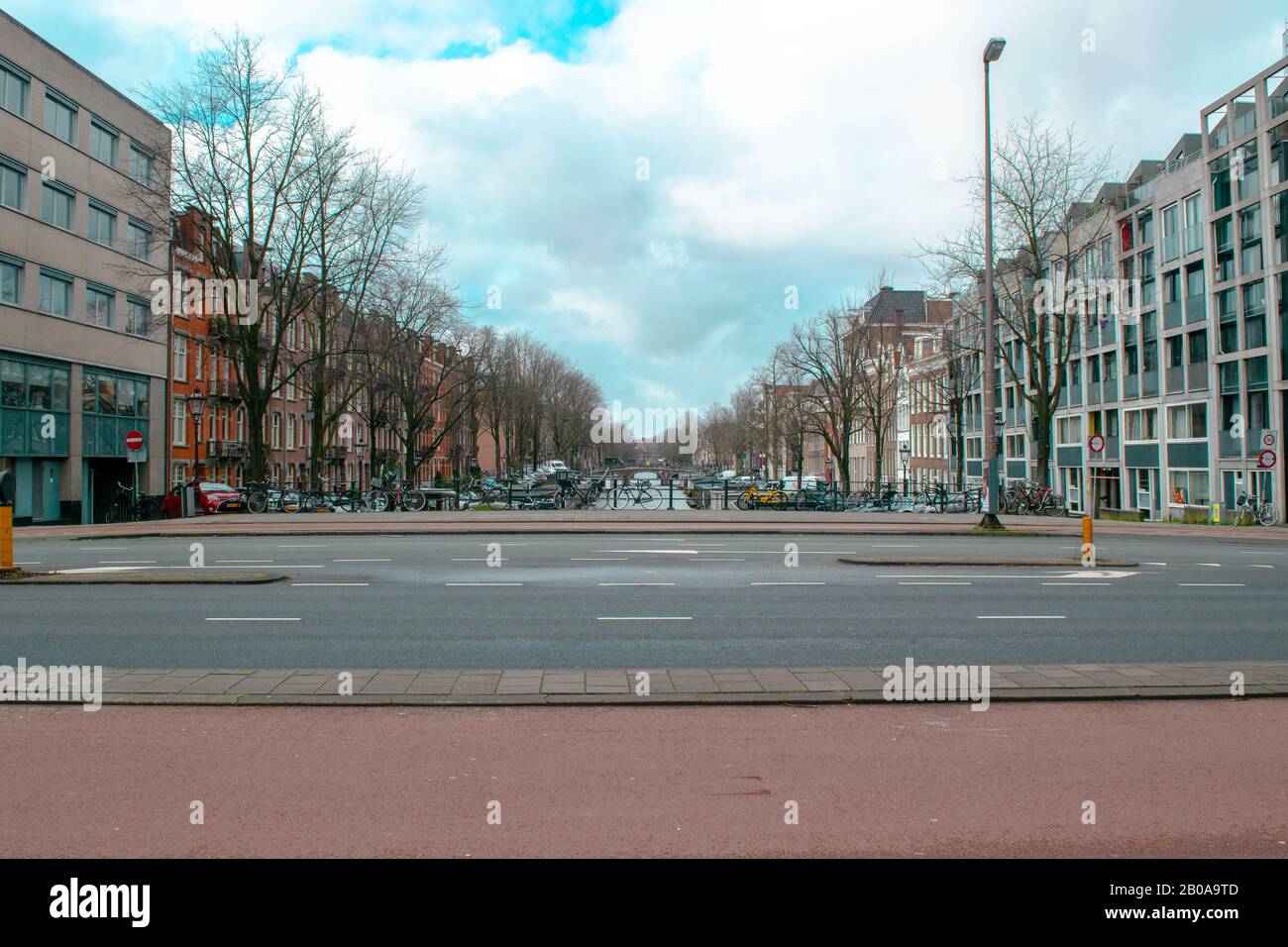 Road in front of Amsterdam canal in the Dutch city of Amsterdam the ...