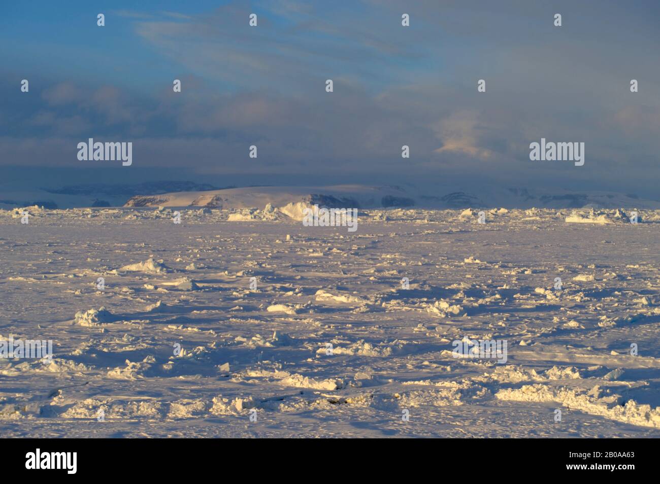 ANTARCTICA, WEDDELL SEA, FAST ICE AND RIDGED SEA ICE WITH SNOW HILL ...
