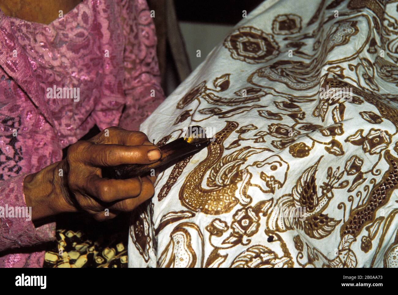 INDONESIA, JAVA, BATIK FACTORY, WOMAN APPLYING WAX TO FABRIC BEFORE ...