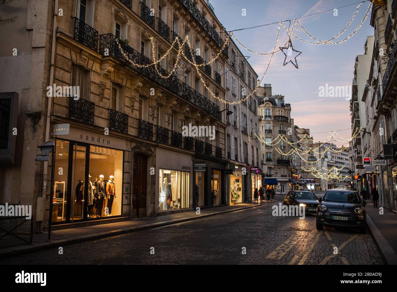 Christmas lights and store windows on a street in Passy, Paris, France ...