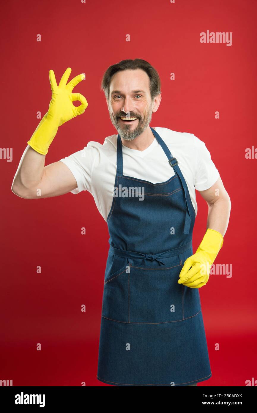 Keeping your home clean. Happy cleaner in yellow gloves show ok sign ...